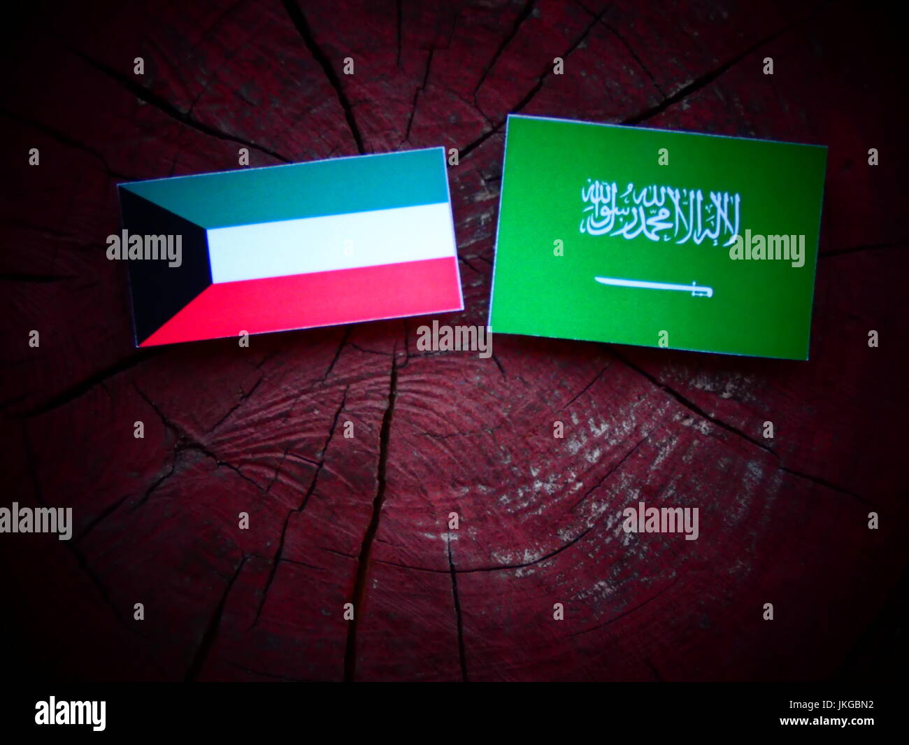 Kuwaiti flag with Saudi Arabian flag on a tree stump isolated Stock ...