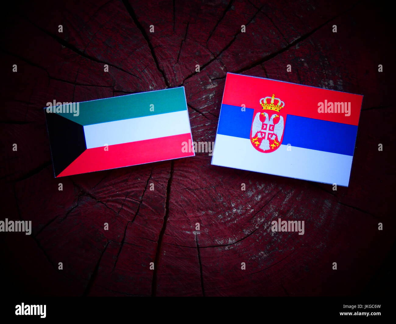 Kuwaiti flag with Serbian flag on a tree stump isolated Stock Photo - Alamy