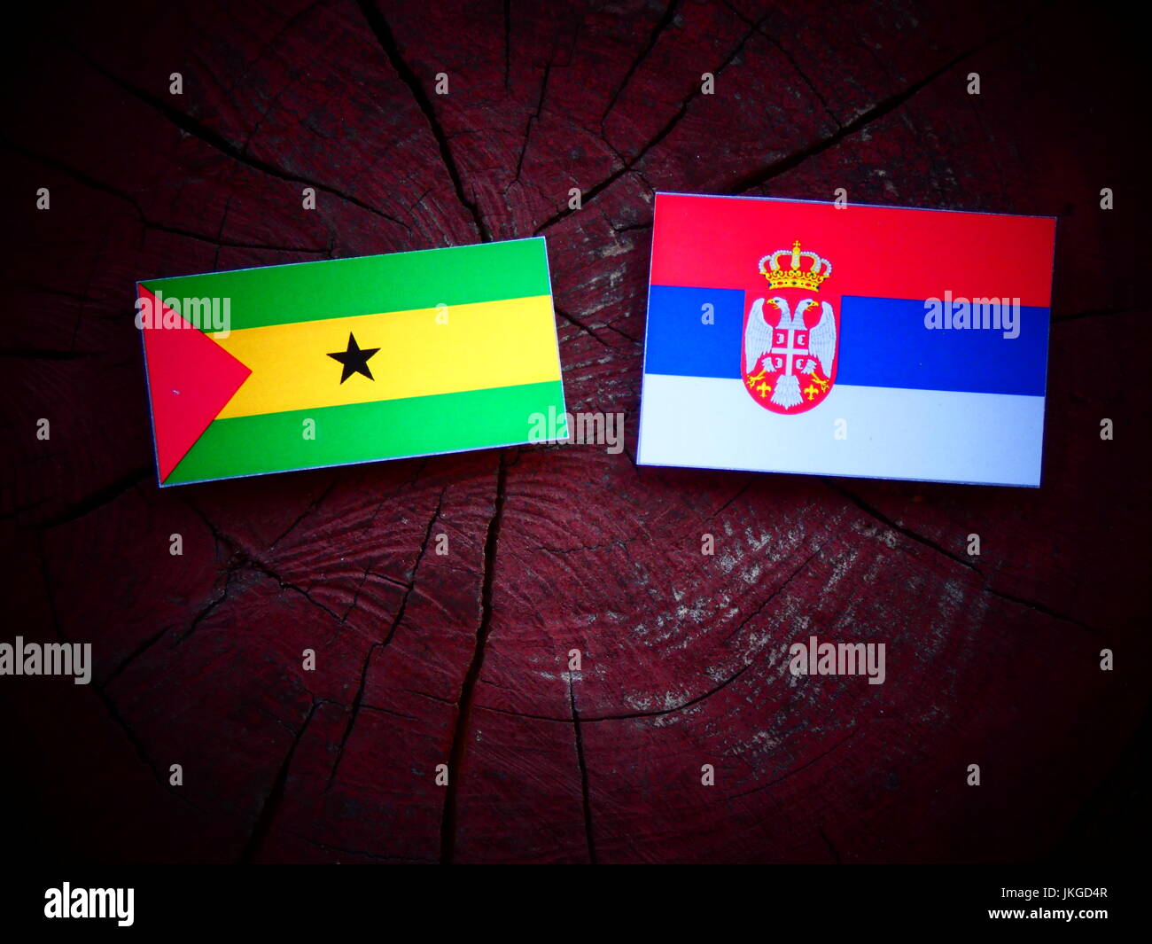 Sao Tome and Principe flag with Serbian flag on a tree stump isolated ...