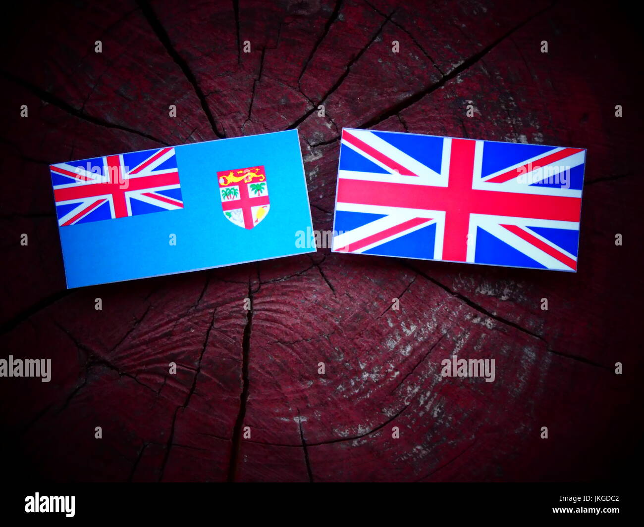 Fijian flag with UK flag on a tree stump isolated Stock Photo - Alamy