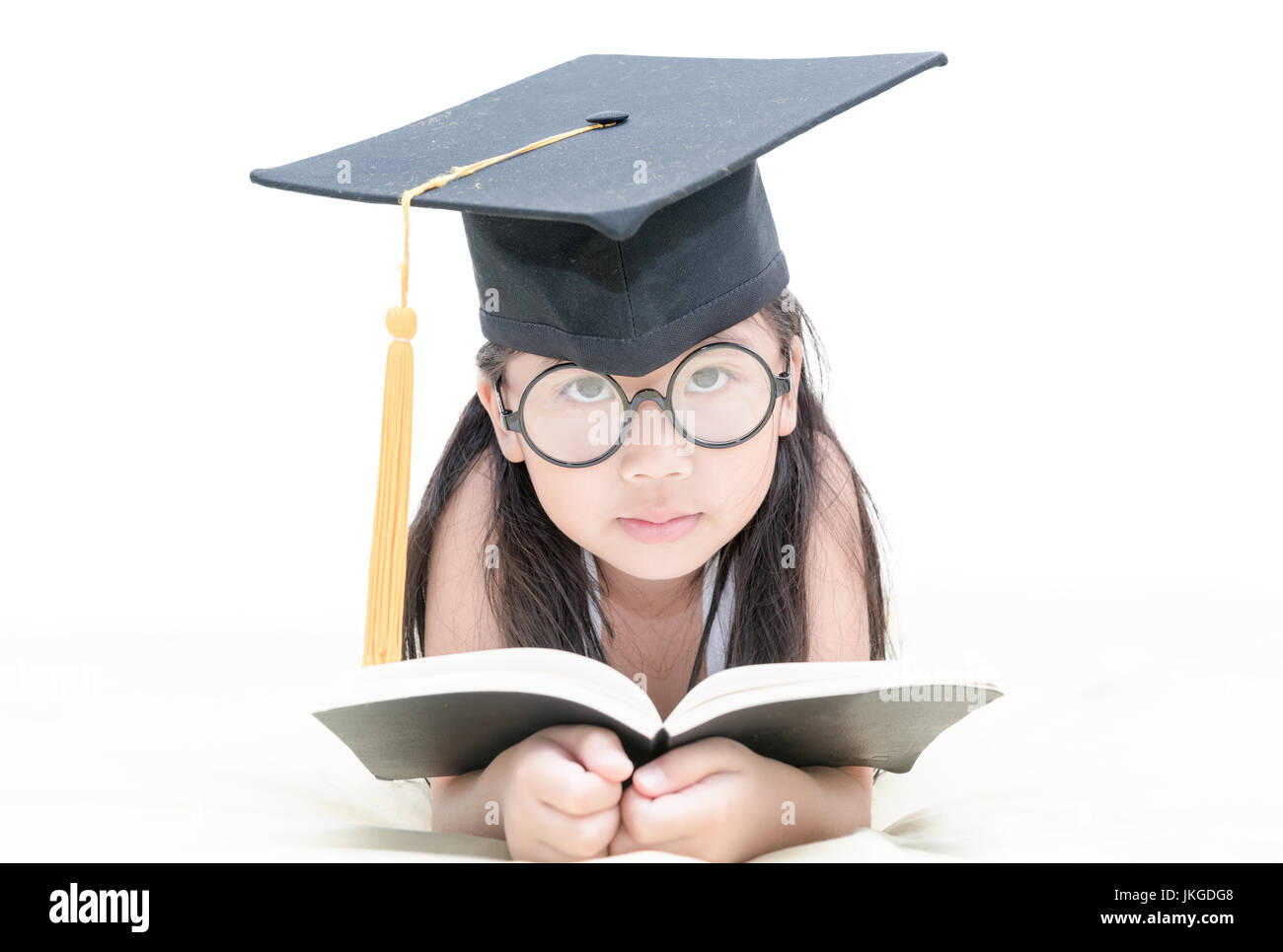 Asian school kid graduate reading book with graduation cap isolated on ...