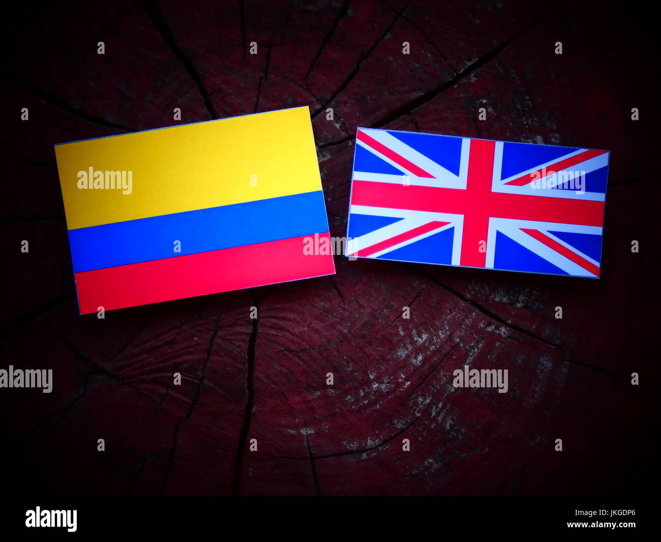 Colombian flag with UK flag on a tree stump isolated Stock Photo - Alamy