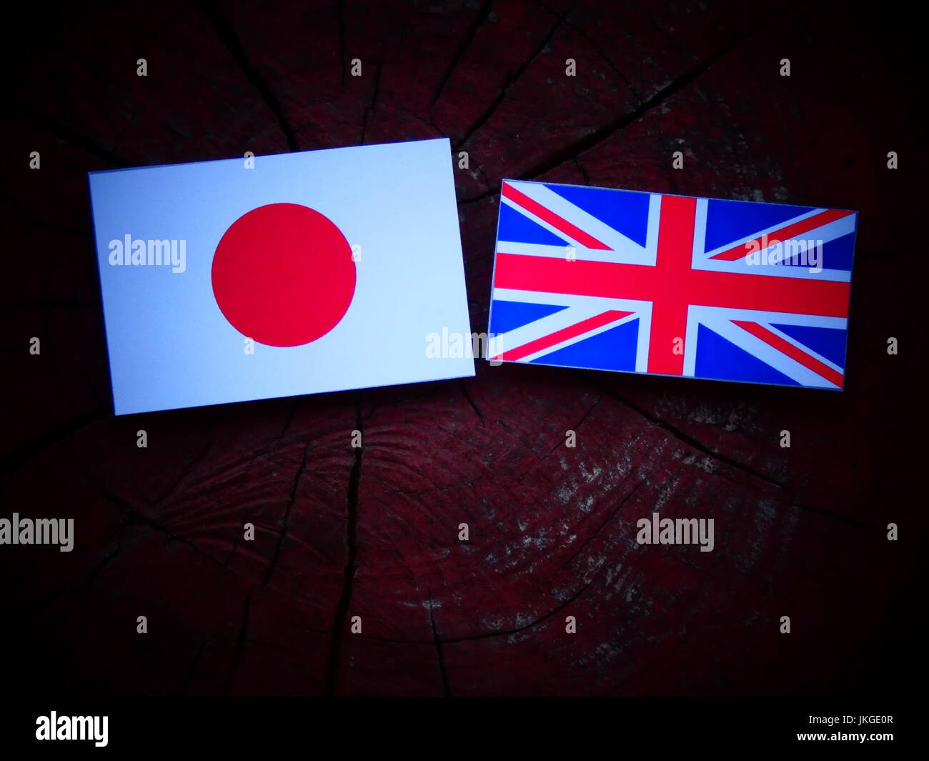 Japanese flag with UK flag on a tree stump isolated Stock Photo - Alamy