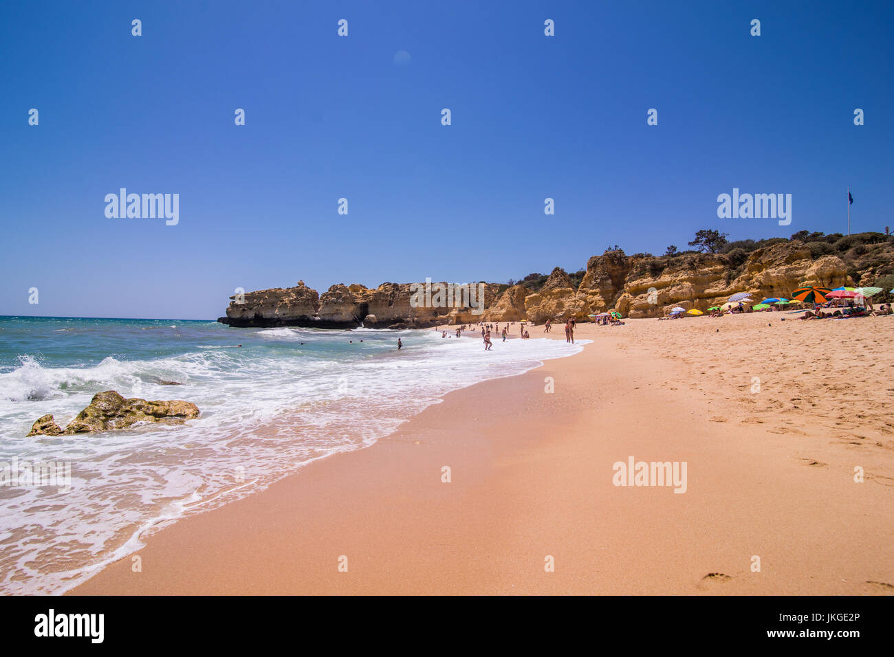 A view of beautiful sandy beach on ocean breeze with cave in summer ...