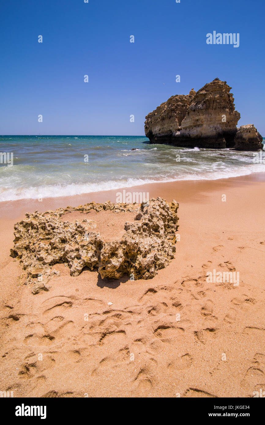 A view of beautiful sandy beach on ocean breeze with cave in summer ...