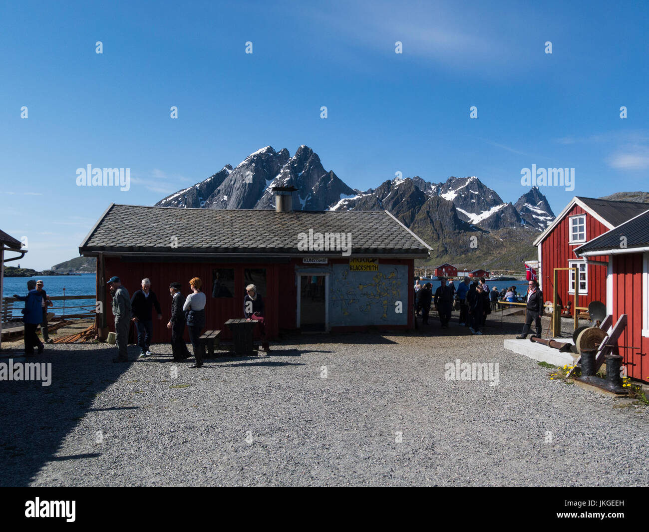 Tourists visiting the popular blacksmith forge in small fishing village ...