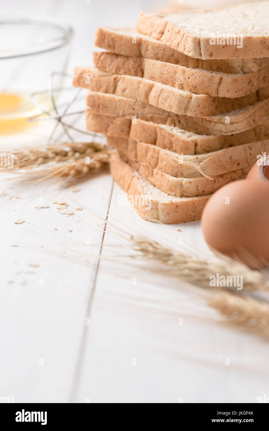 slice bread with ingredients for making bread on with wood background ...