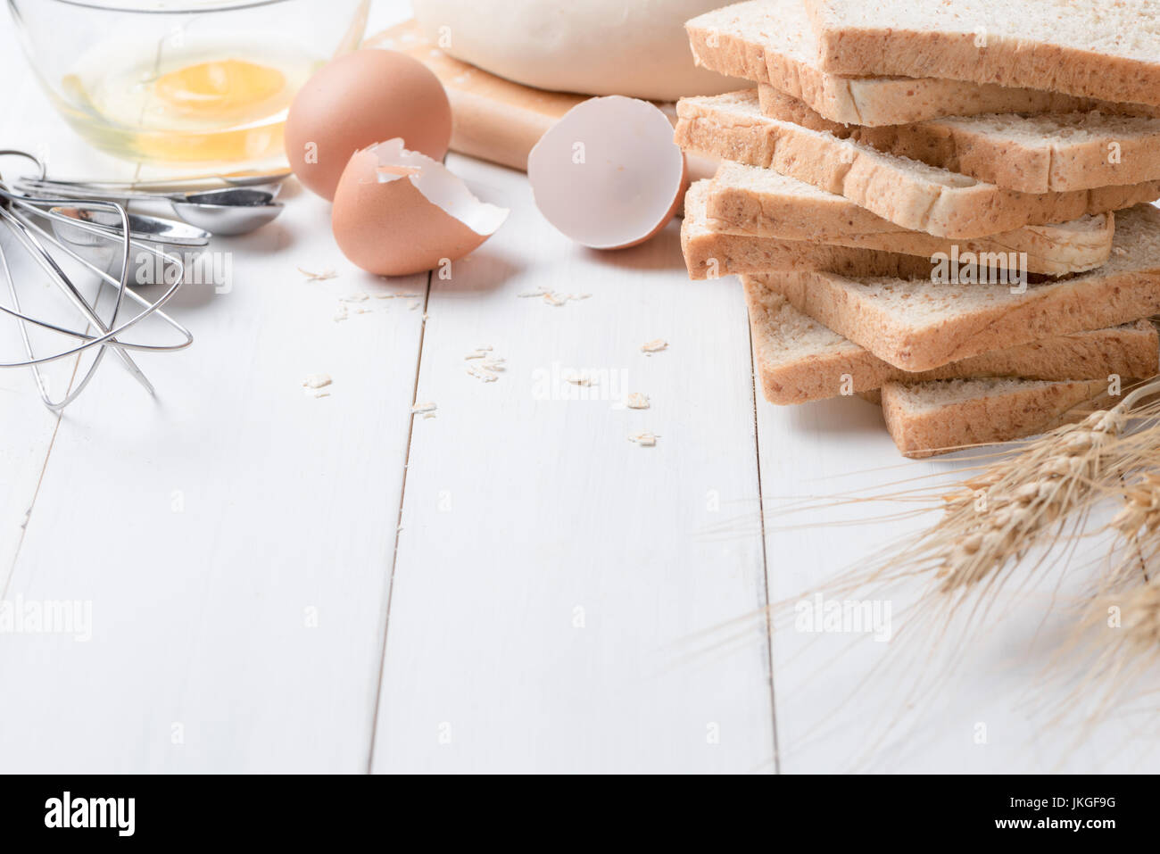 slice bread with ingredients for making bread on with wood background ...