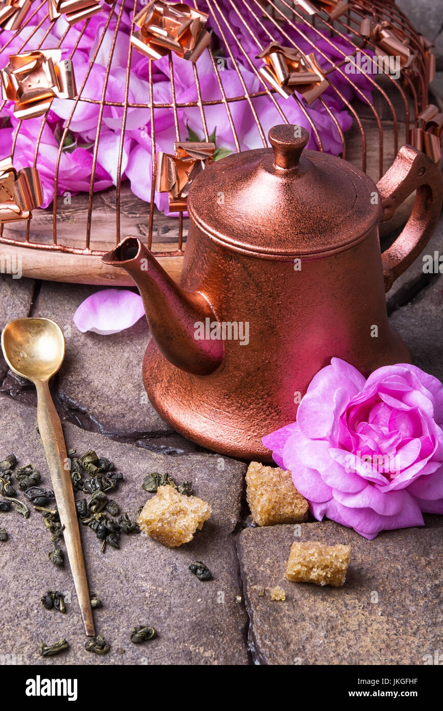 Copper stylish tea pot with tea rose Stock Photo - Alamy