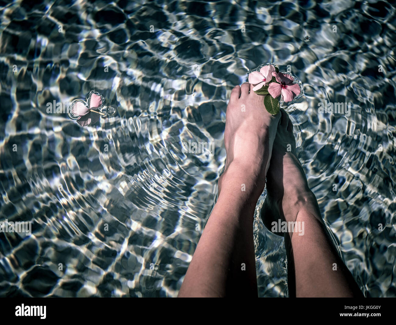 POV Young Lady with feet in water flower between toes Stock Photo - Alamy