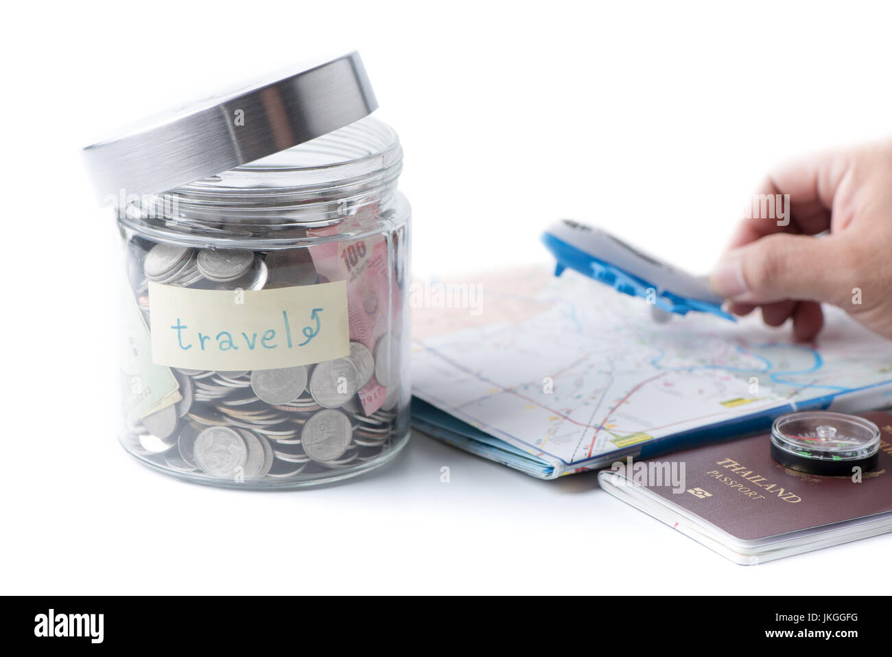 Travel budget concept. travel money savings in a glass jar with compass ...