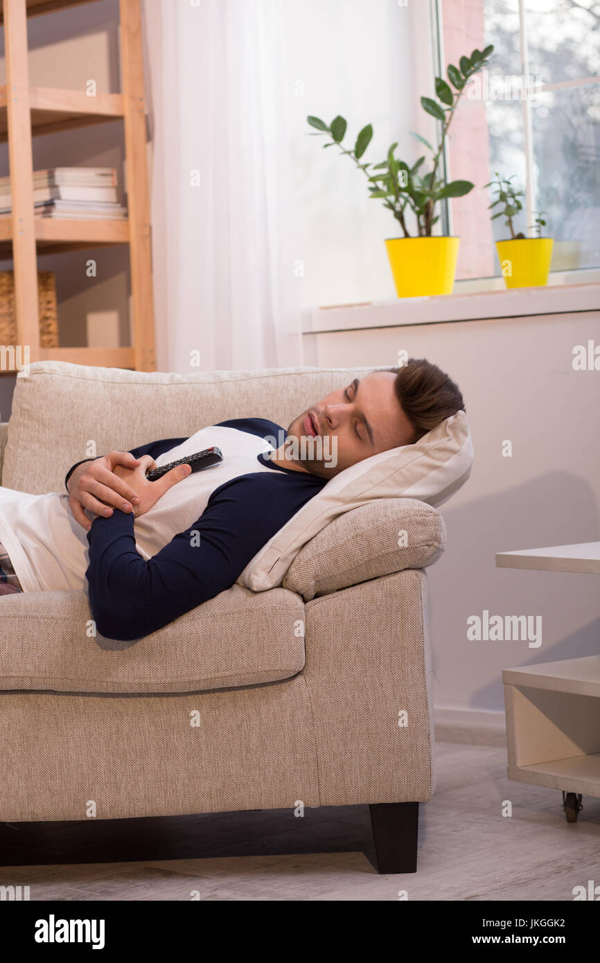 Man lounging on sofa lazy hi-res stock photography and images - Alamy