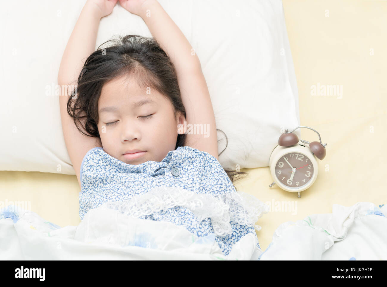 cute girl sleep on bed with alarm clock in morning Stock Photo - Alamy