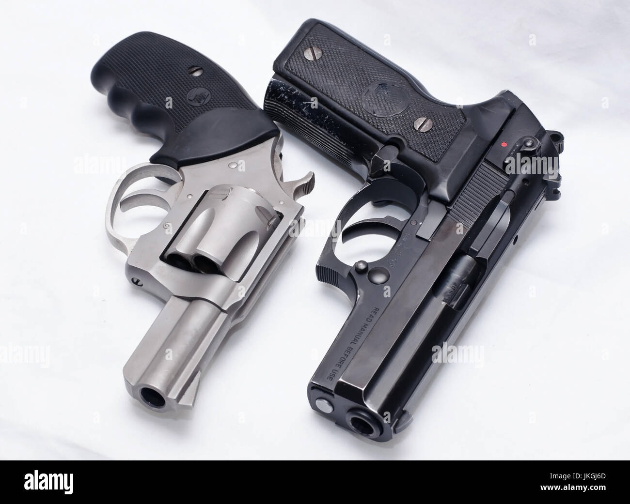 Side by side stainless revolver with a black semi auto pistol Stock ...