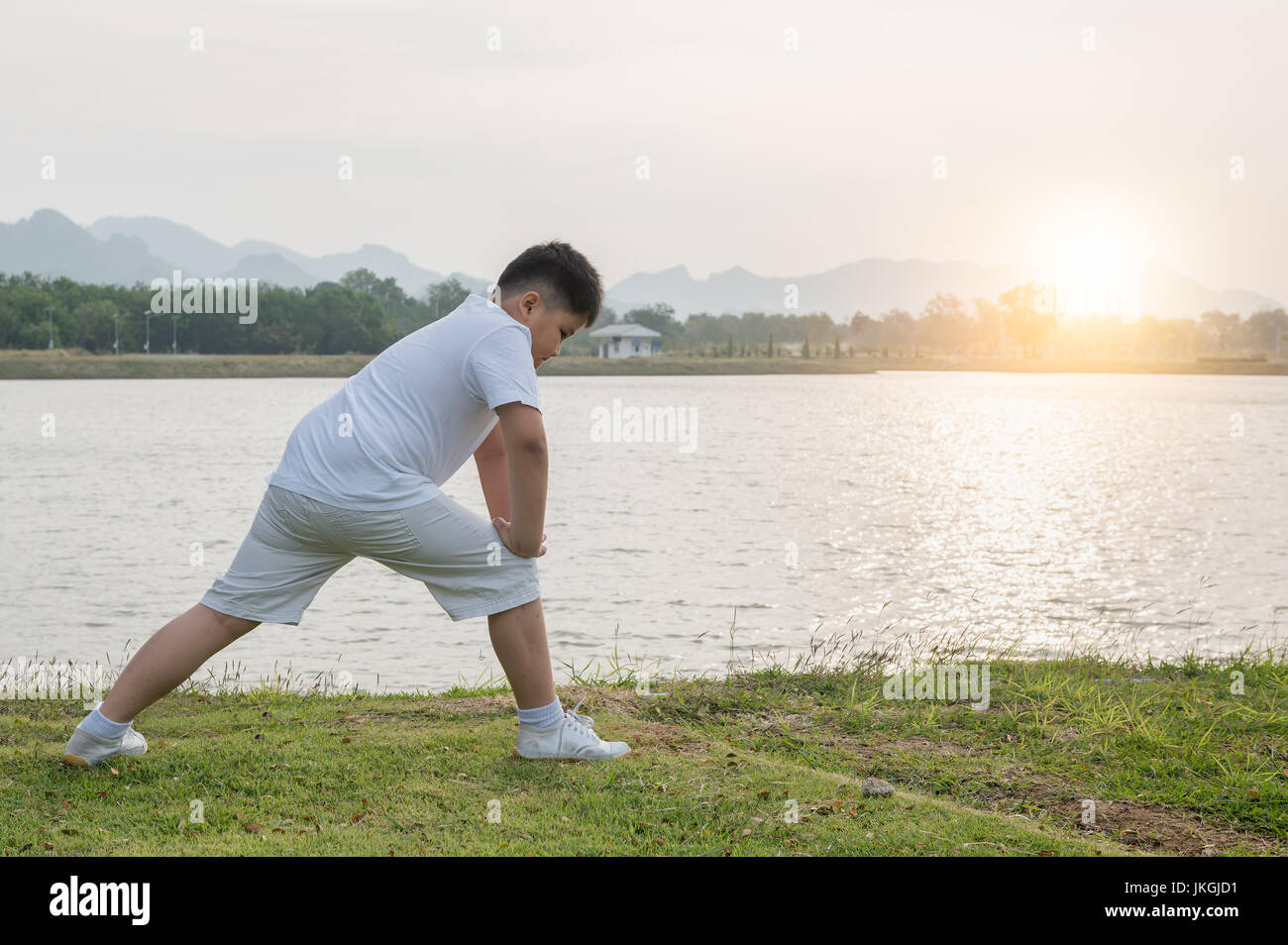 Obese fat boy exercise at park on morning in sunrise, concept diet and ...