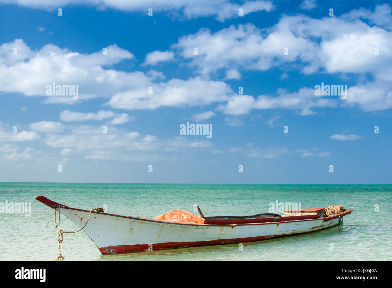 Canoe floating on calm water under beautiful blue sky Stock Photo - Alamy