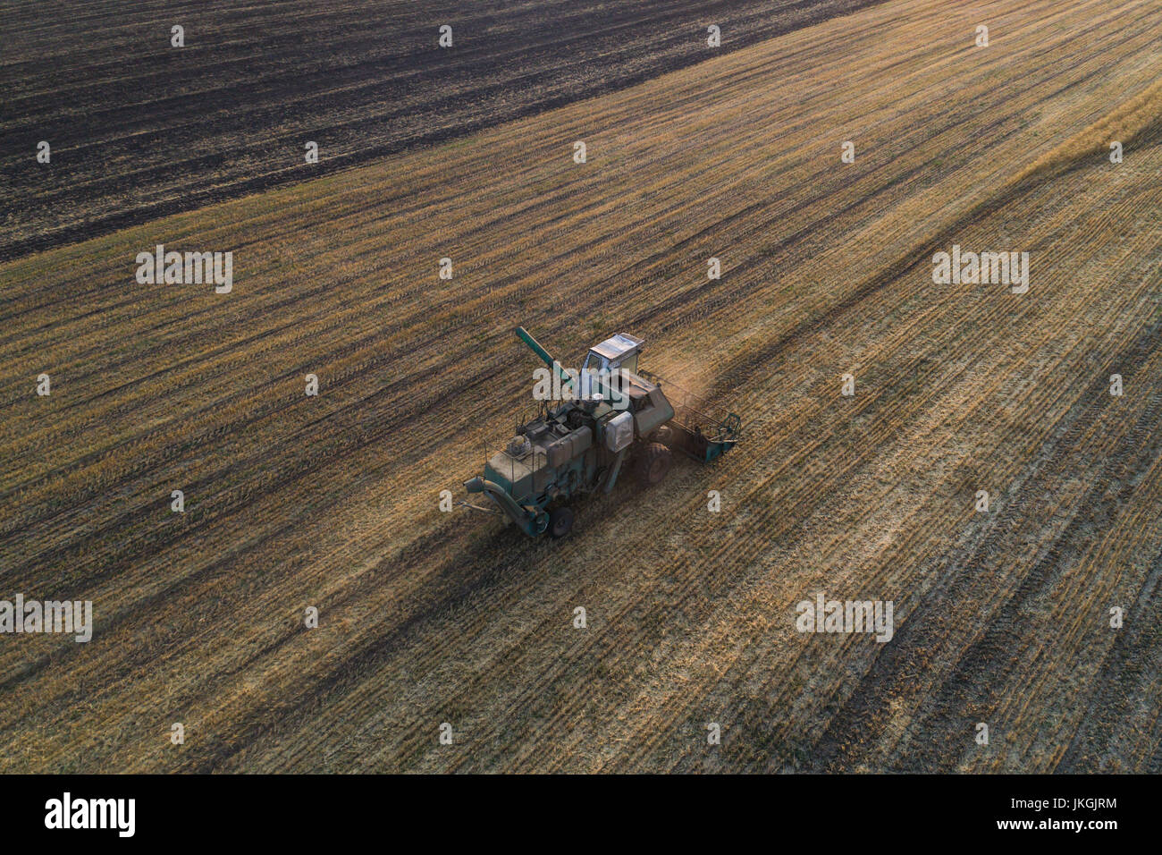 Harvester machine working in field . Combine harvester agriculture ...