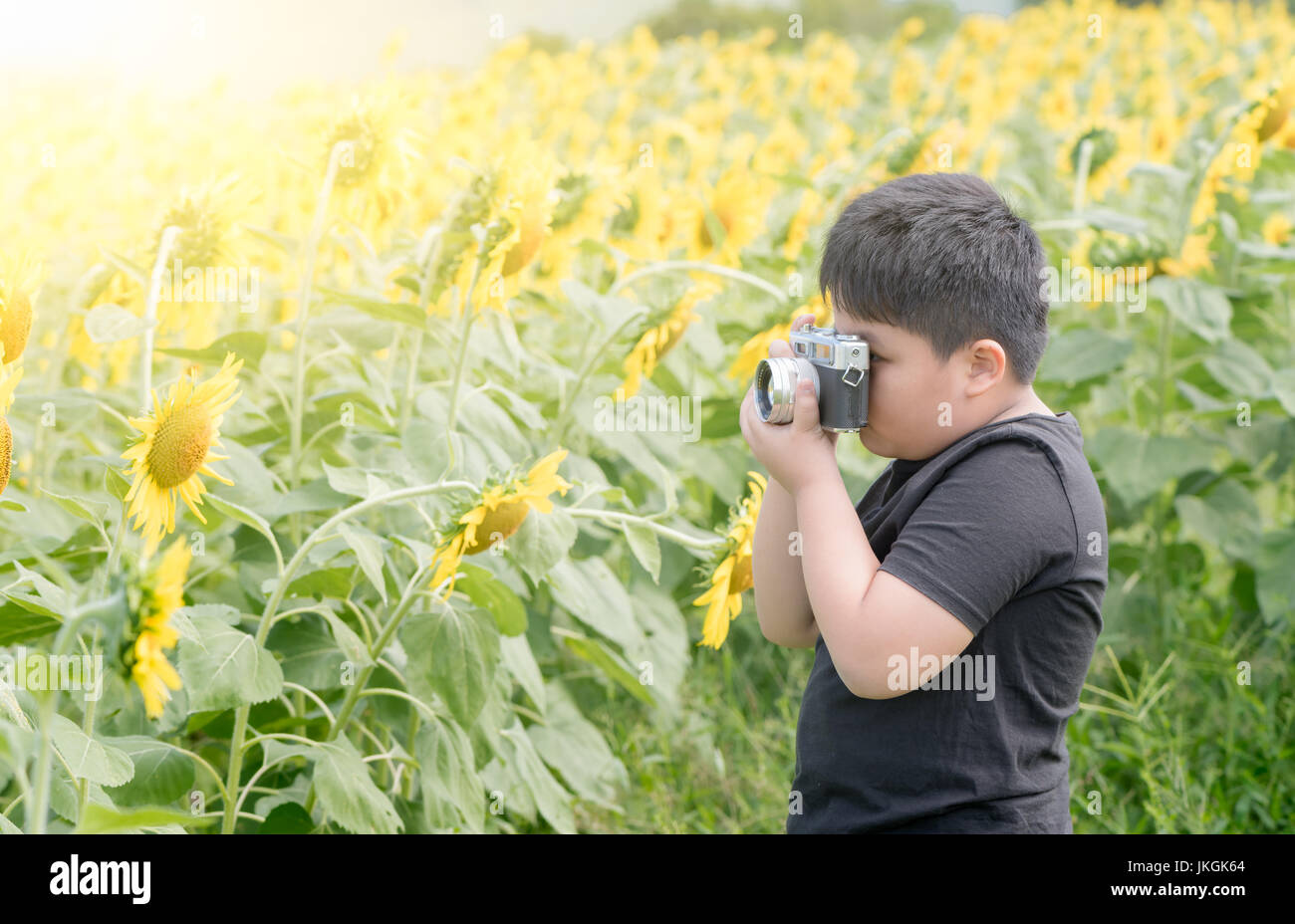 fat boy holding vintage camera / Child Holding old camera to Take ...