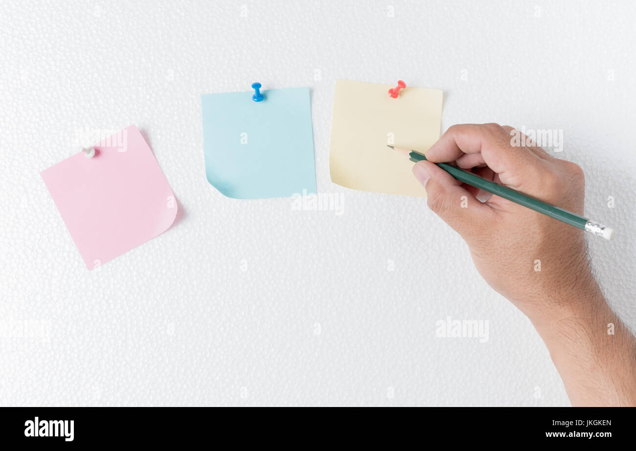 hand man write on paper note with pin on foam sheet, concept remember ...