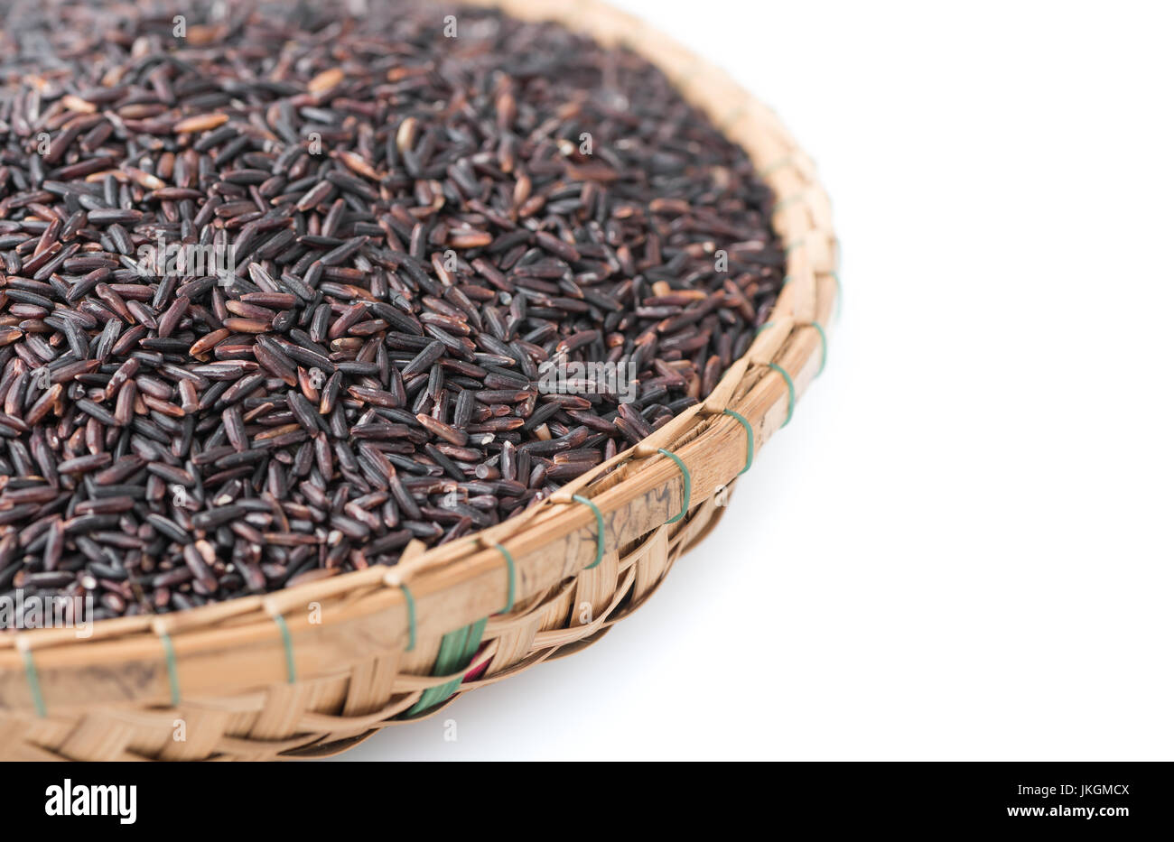 closed up of rice berry on bamboo basket isolated on white background ...