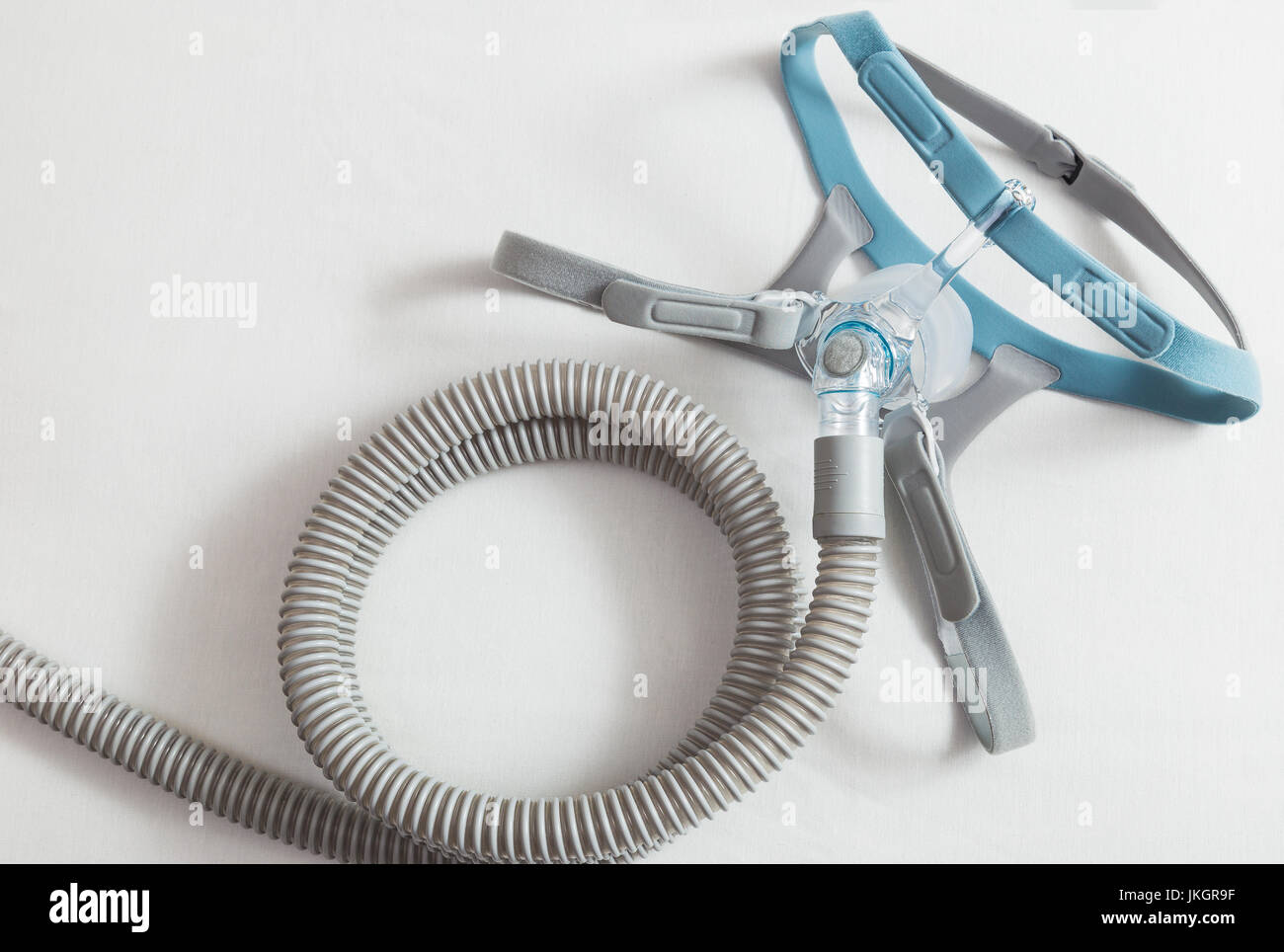 CPAP headgear mask, connecting with strap and hose laying on a bed, for ...