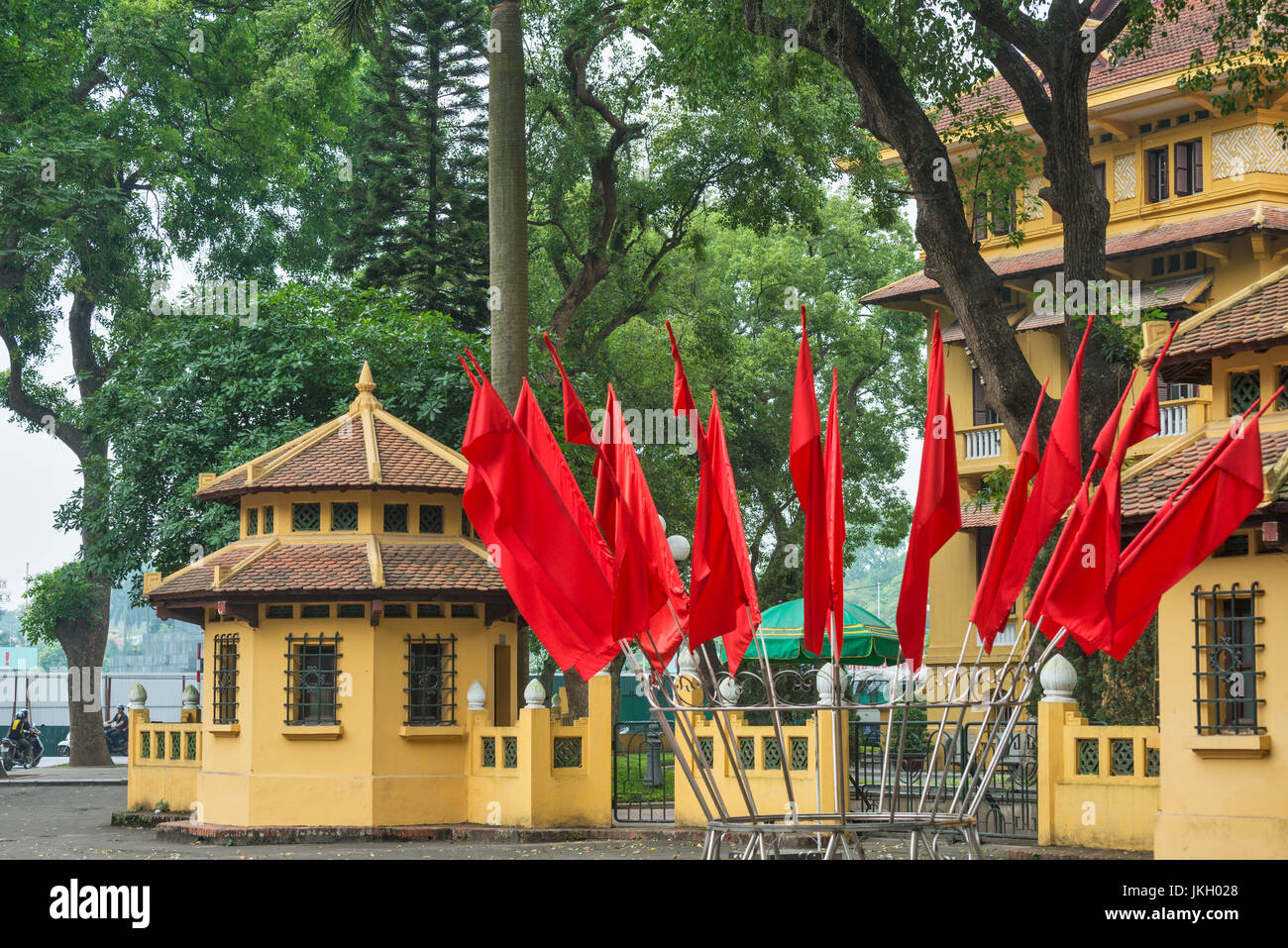 Street scene and red flags at Hanoi near the Ho Chi Minh memorial ...
