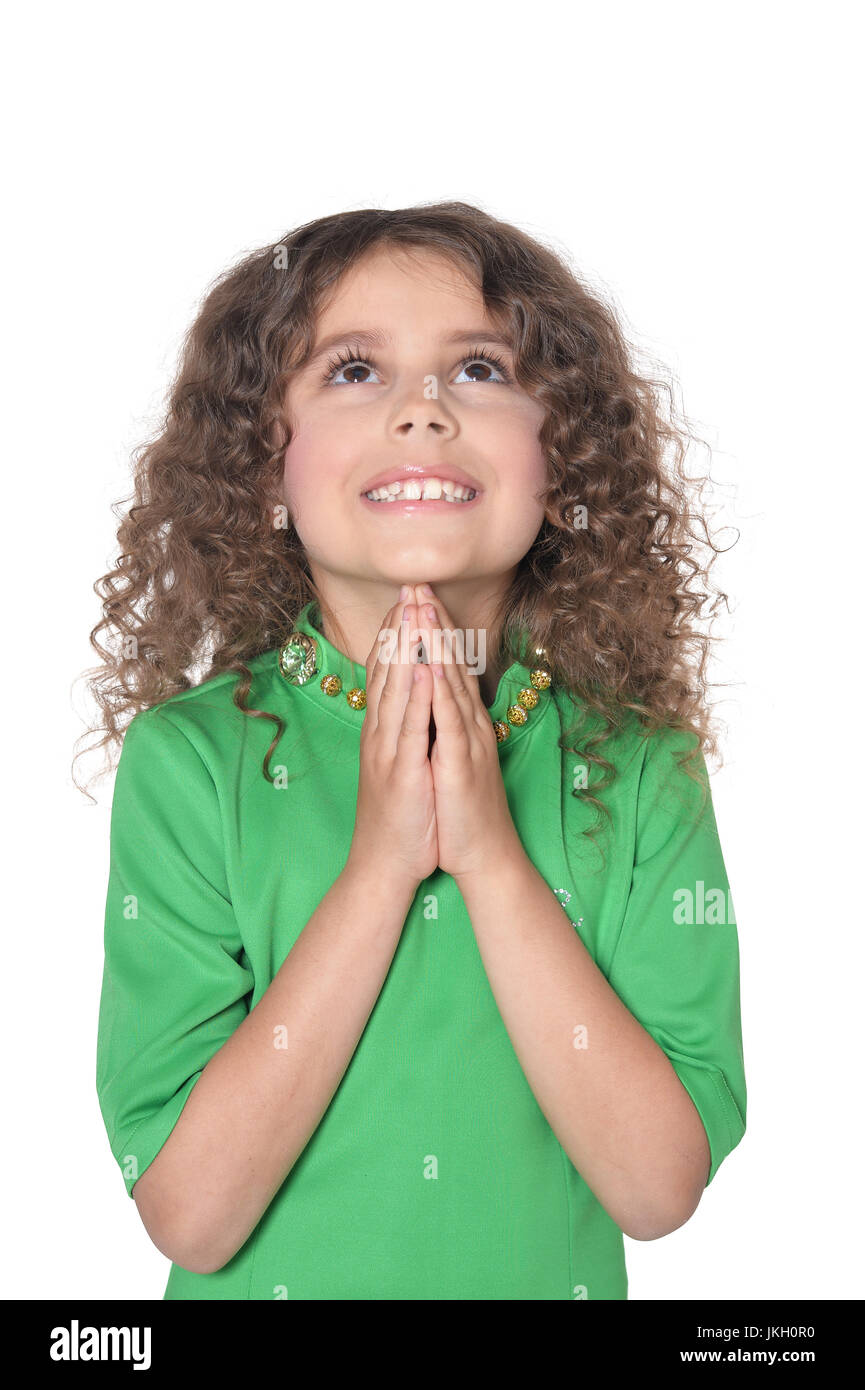 Cute little girl praying isolated on white background Stock Photo - Alamy