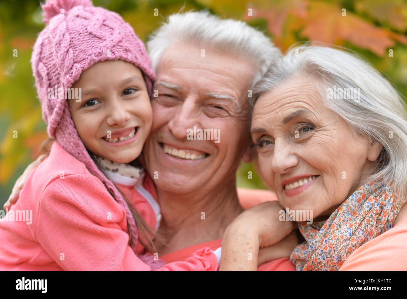 Family portrait of happy grandparents and granddaughter Stock Photo - Alamy