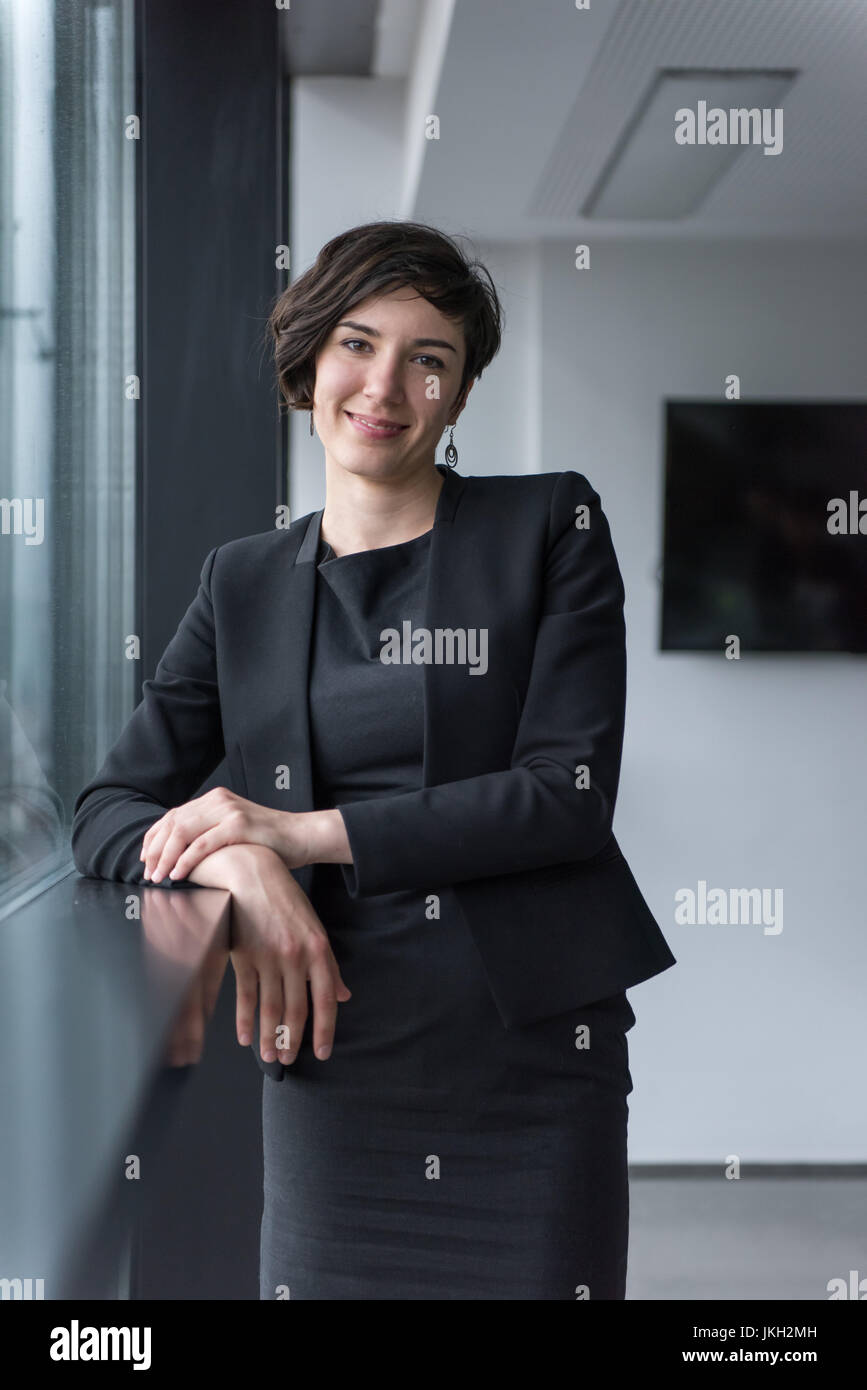 Portrait Of Successful Businesswoman by the window Entrepreneur At Busy ...
