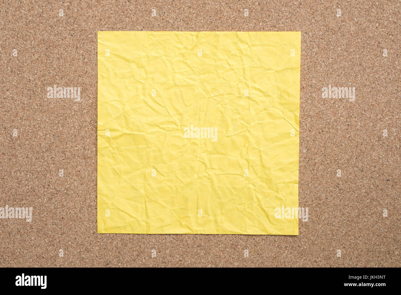 yellow color creased paper note on cork background Stock Photo - Alamy