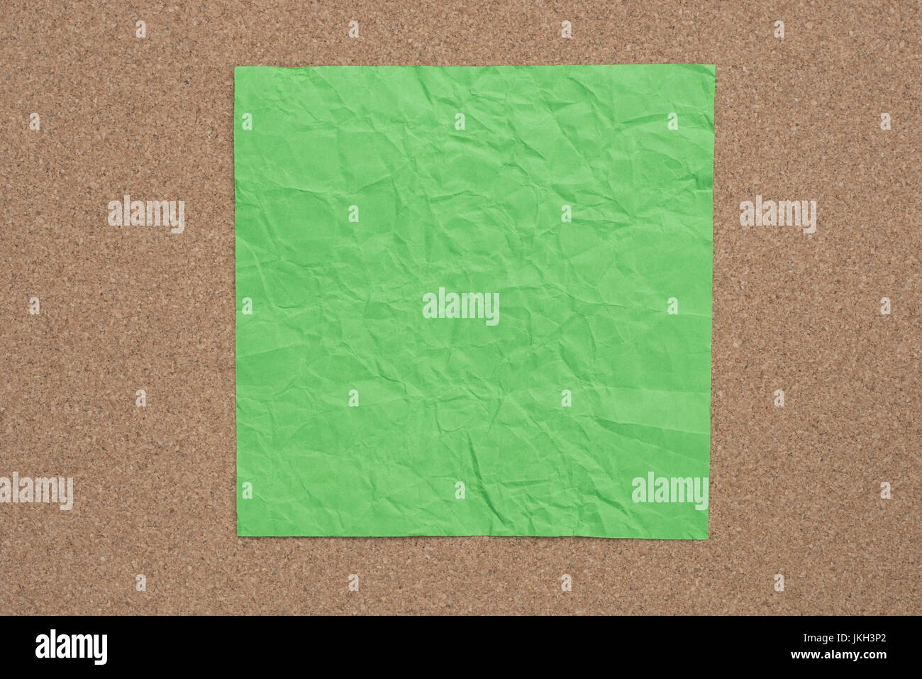 green color creased paper note on cork background Stock Photo - Alamy