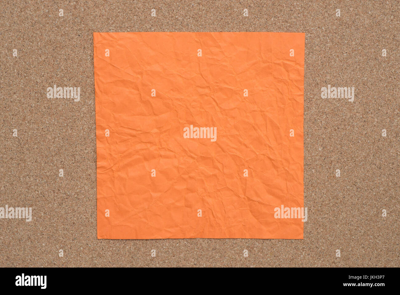 orange color creased paper note on cork background Stock Photo - Alamy