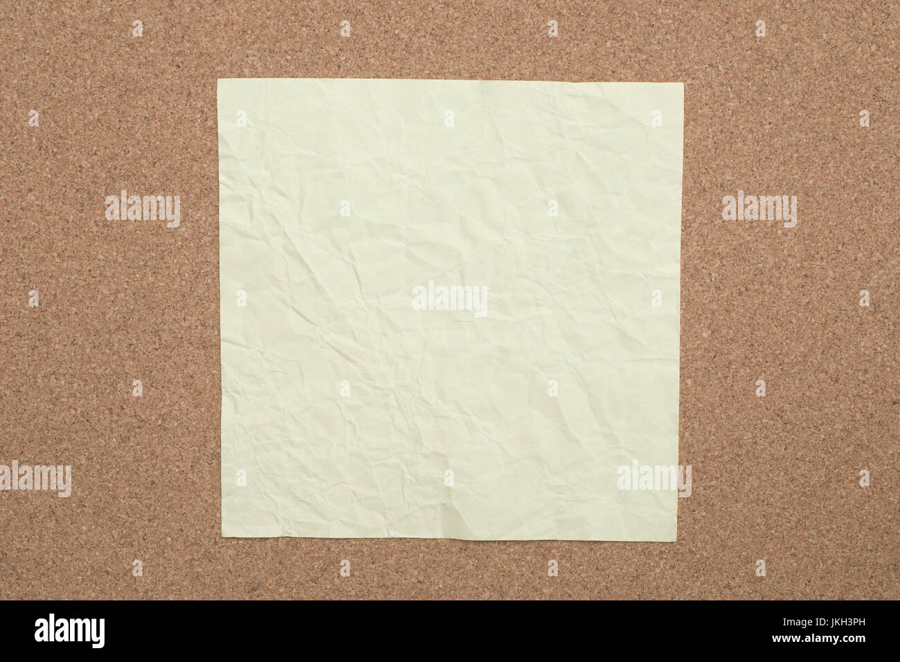 yellow color creased paper note on cork background Stock Photo - Alamy