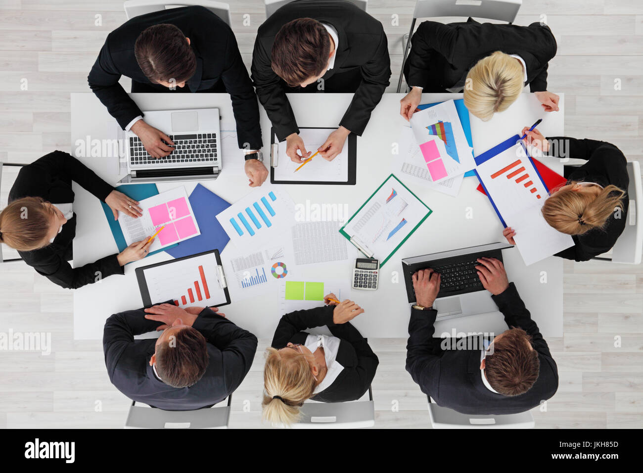 Business people work with statistics documents with tables and diagrams ...