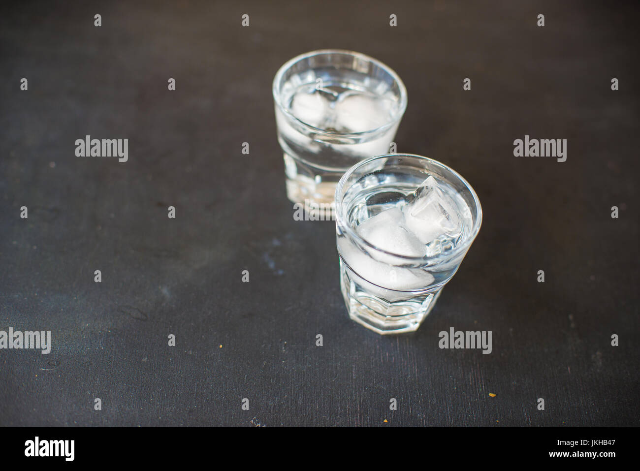 Summer drink glass of water with ice on dark background Stock Photo - Alamy