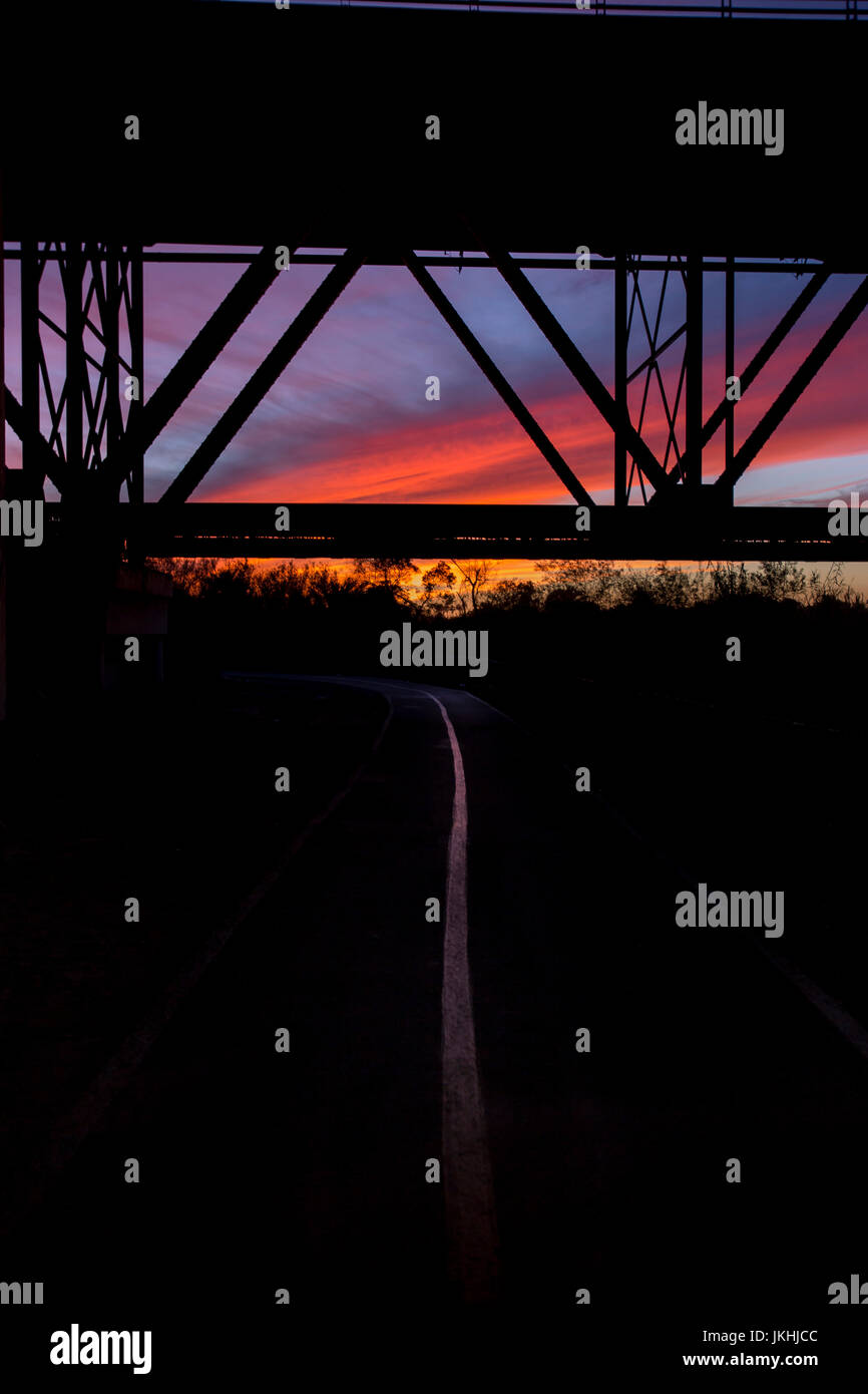 The center line is lit up and there are the beams of a bridge in the ...