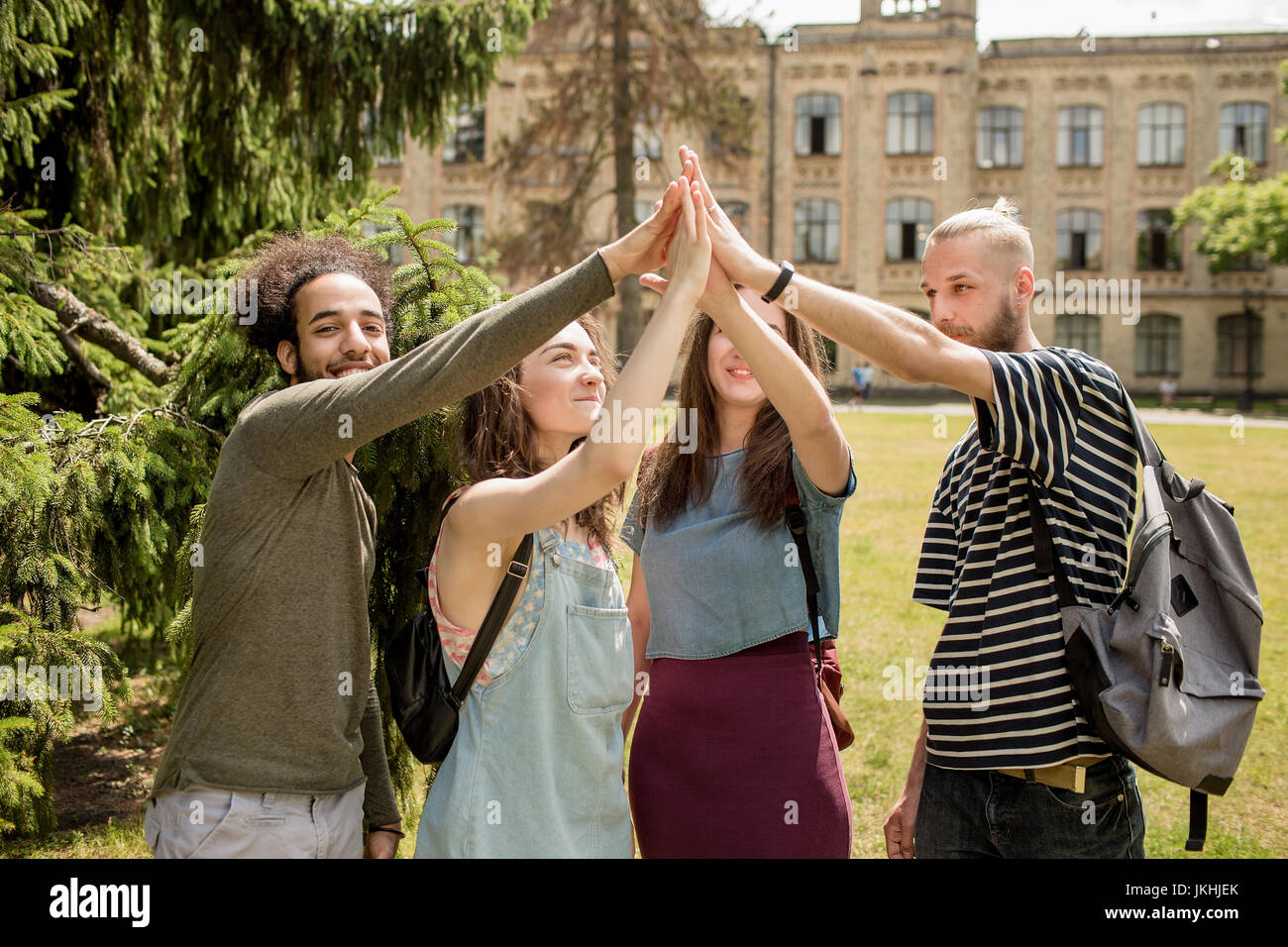 Students at campus rising hands Stock Photo - Alamy