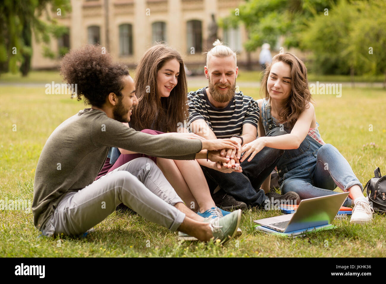 Group of students sitting on grass in University garden Stock Photo - Alamy