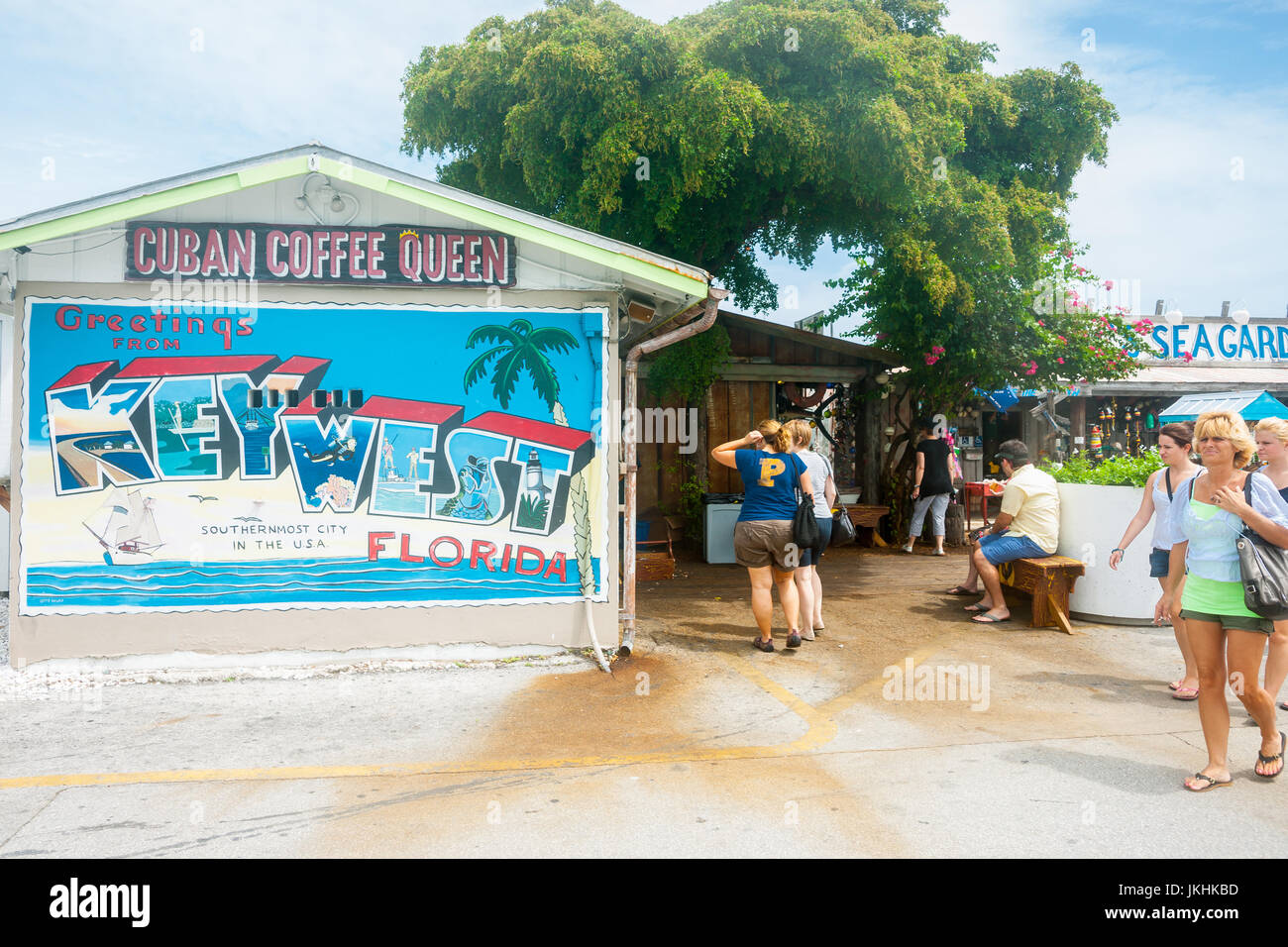 Large cafe sign with greetings from Key West message and tourists ...