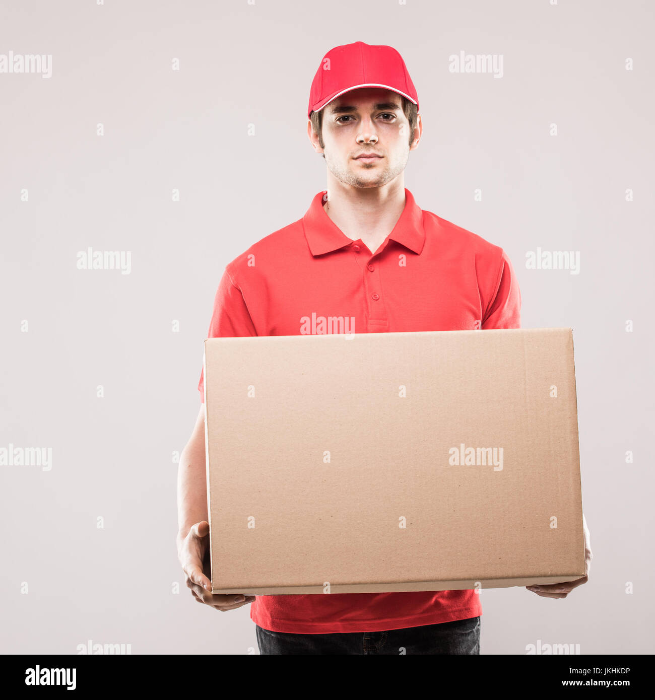 Young smile delivery man with boxes white back Stock Photo - Alamy