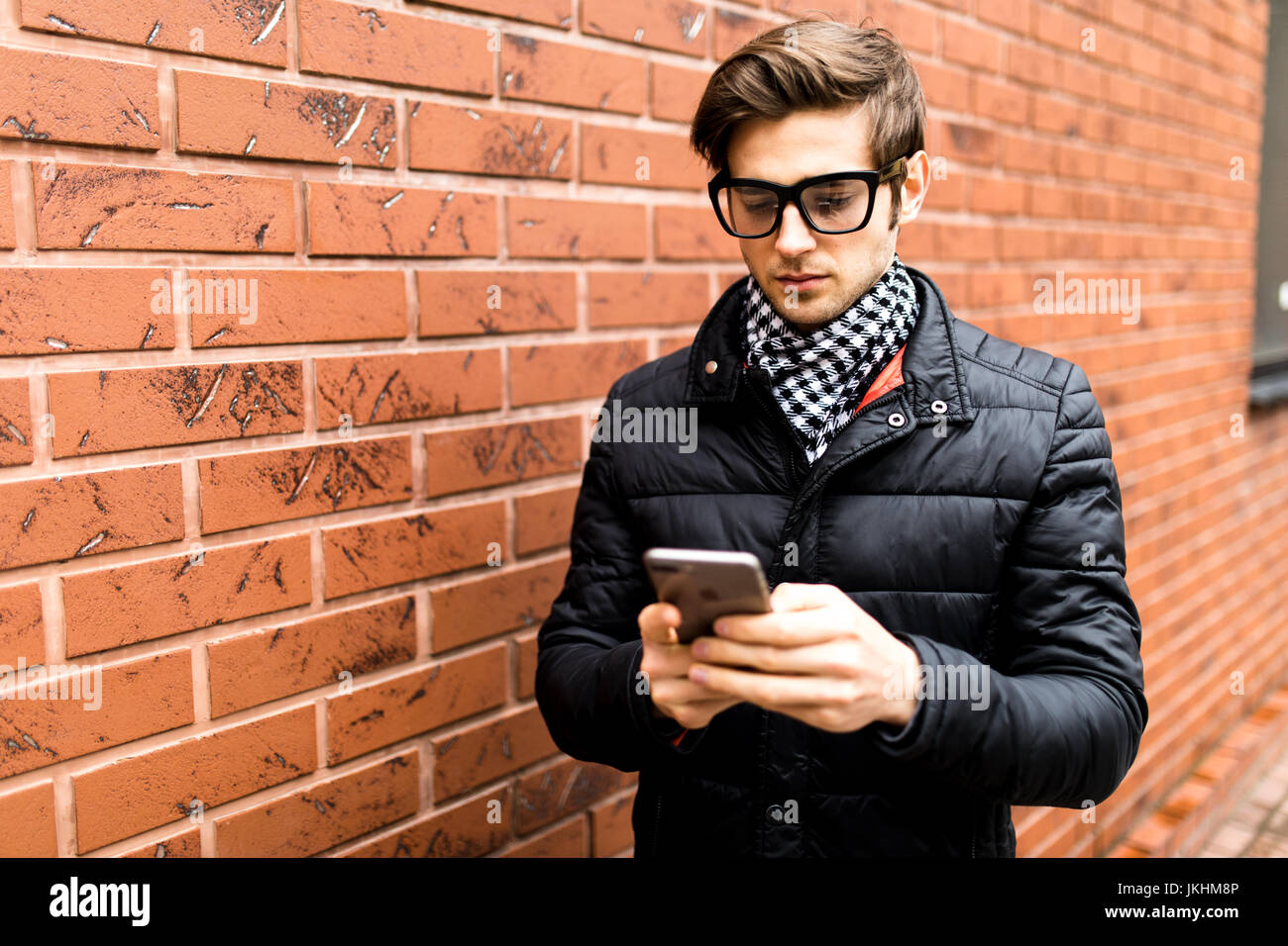 Typing text message side view of handsome young man in smart casual ...