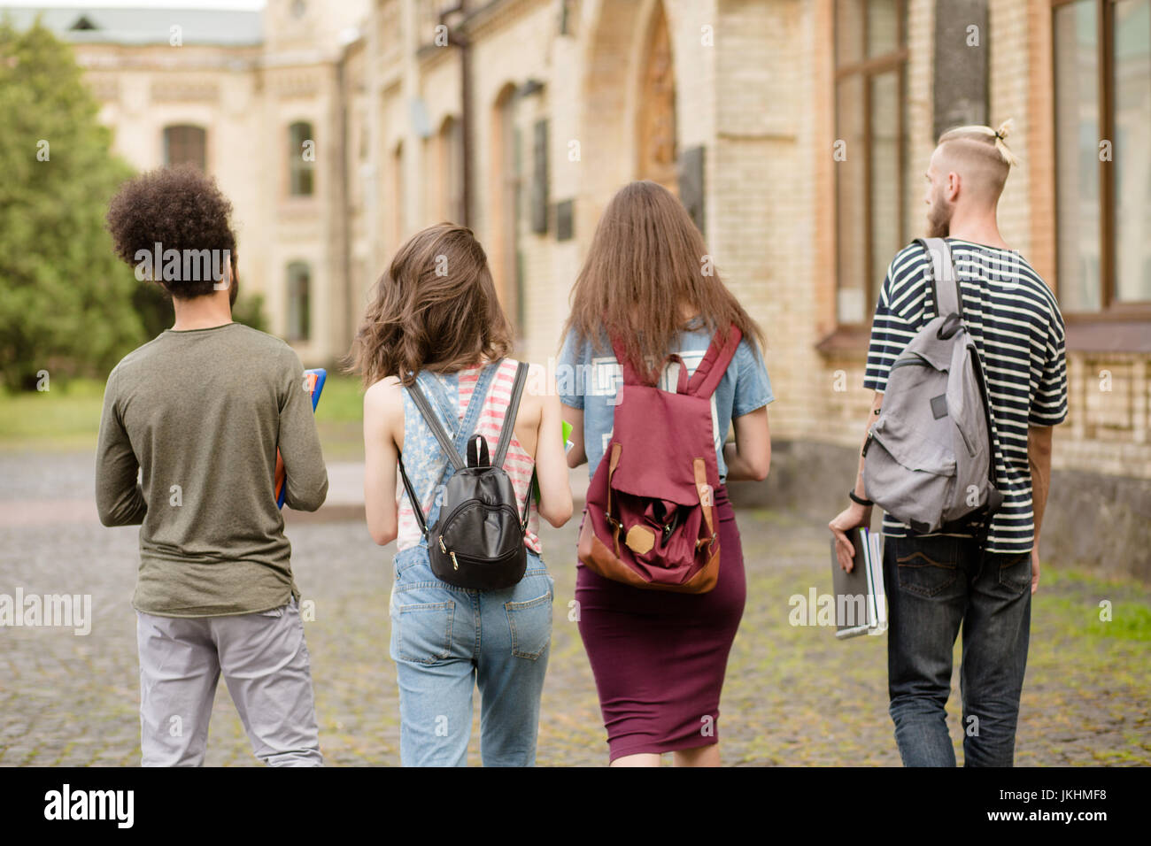 Student friends going together to university Stock Photo - Alamy