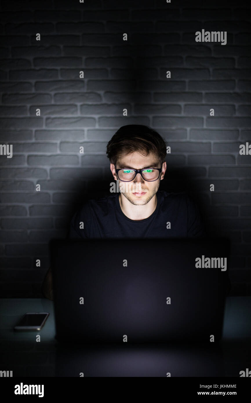Businessman working with computer at night. Hacker Stock Photo - Alamy