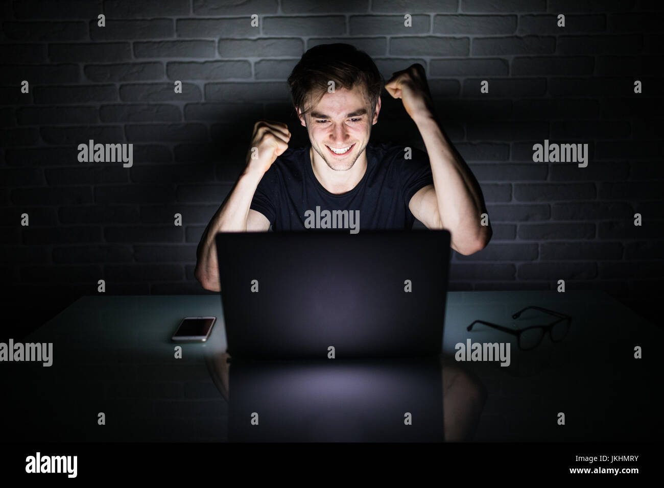 Cheerful man with a victorious gesture in bed excited man with victory ...