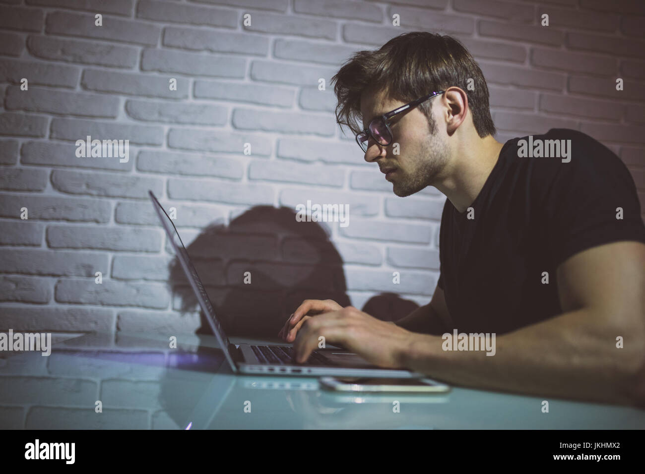 Handsome young programmer working at home late in evening. Hacker Stock ...
