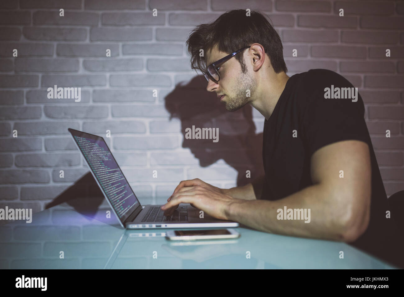Handsome young programmer working at home late in evening. Hacker Stock ...