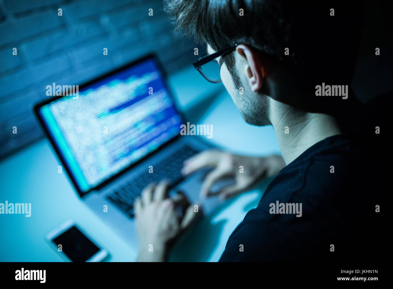 Man using laptop writing programming code on laptop Stock Photo - Alamy