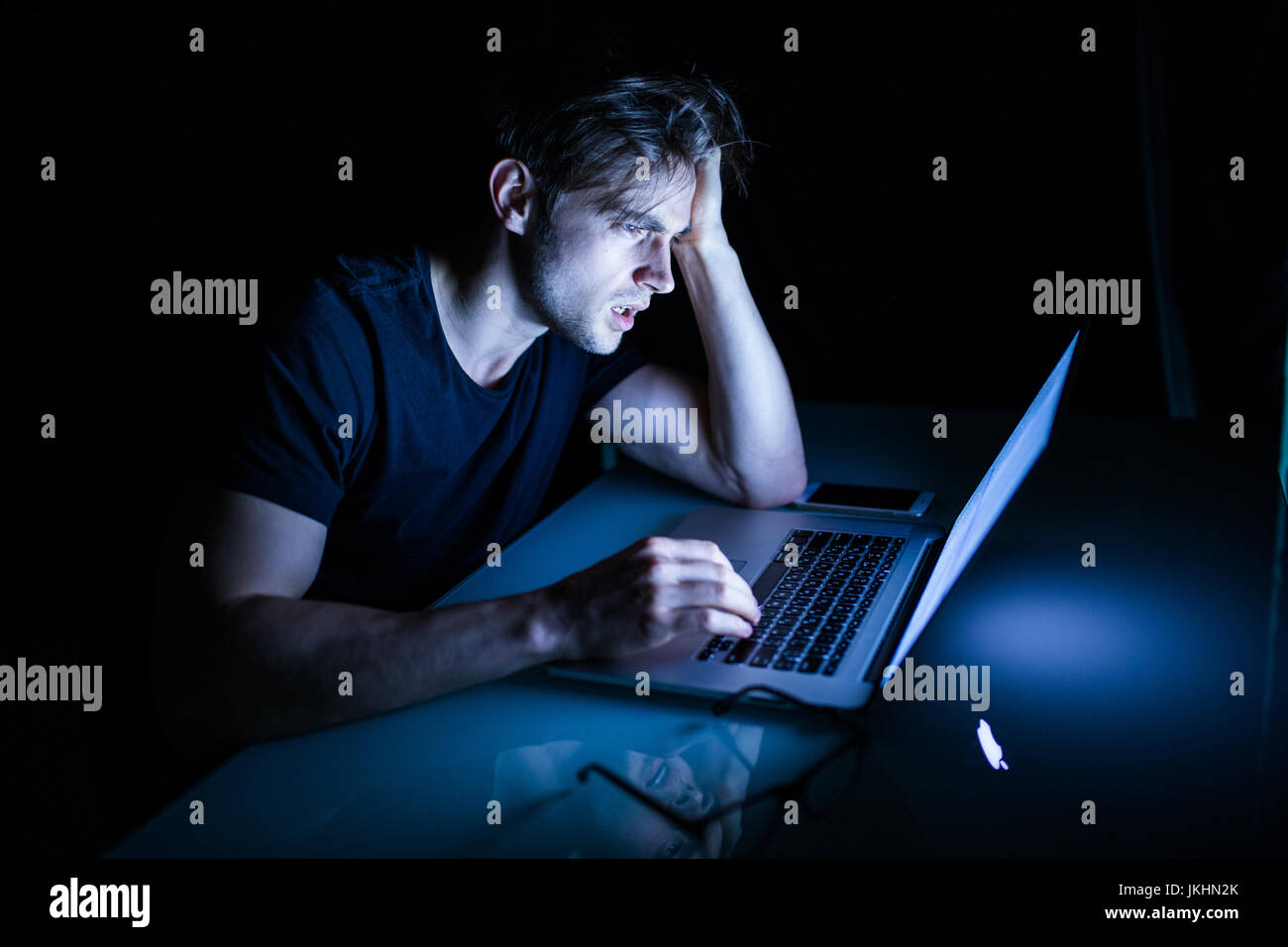 Feeling exhausted frustrated young man while sitting in front of laptop ...