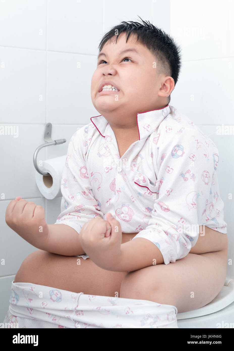 Fat boy sitting on the toilet, concept of diarrhea or constipation ...