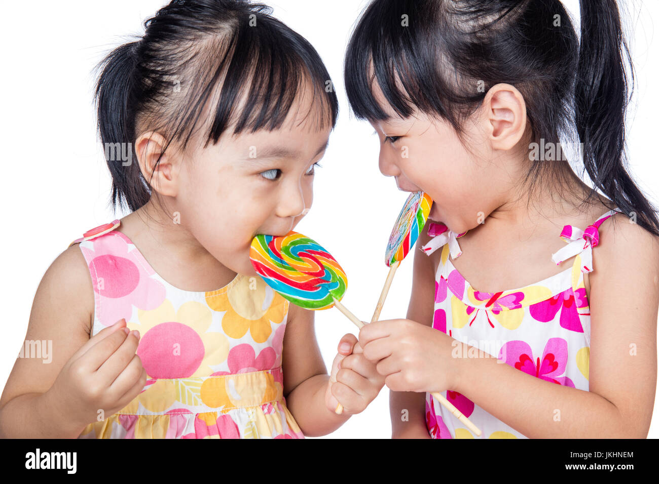 Asian Little Chinese girls eating lollipop in isolated white background ...